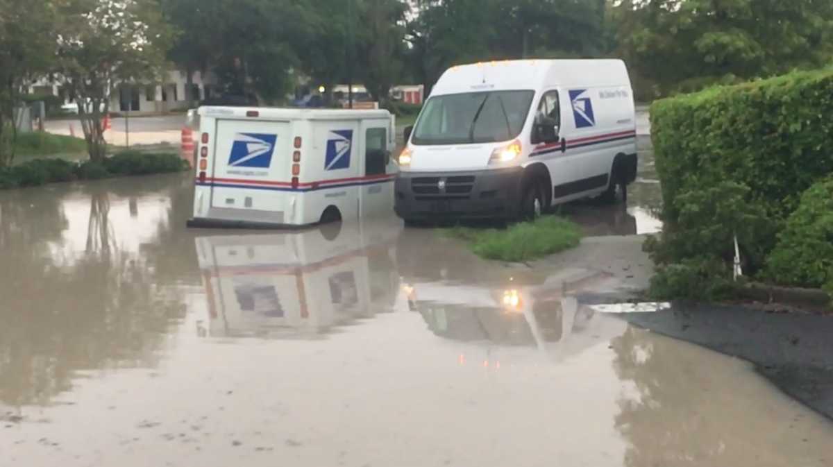 Clogged rain floods I-4; mail truck driver rescued