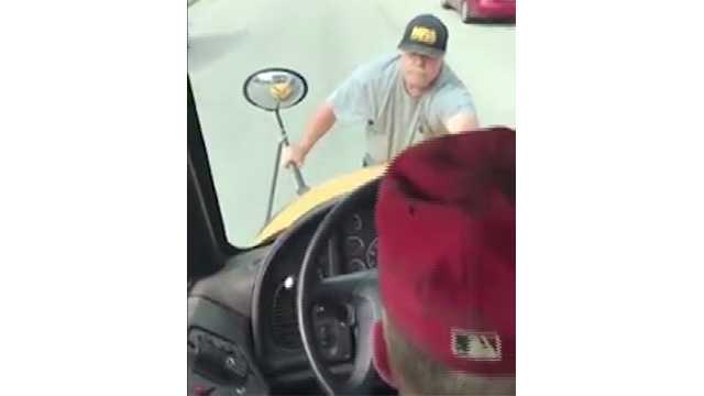 School bus driver reassigned after man clung to moving bus