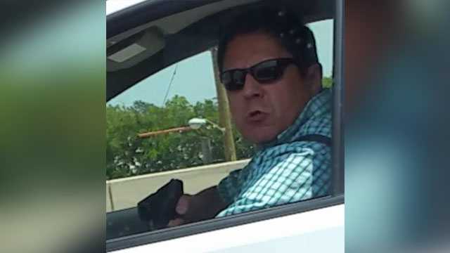 Woman records fellow driver pointing gun at her on the highway