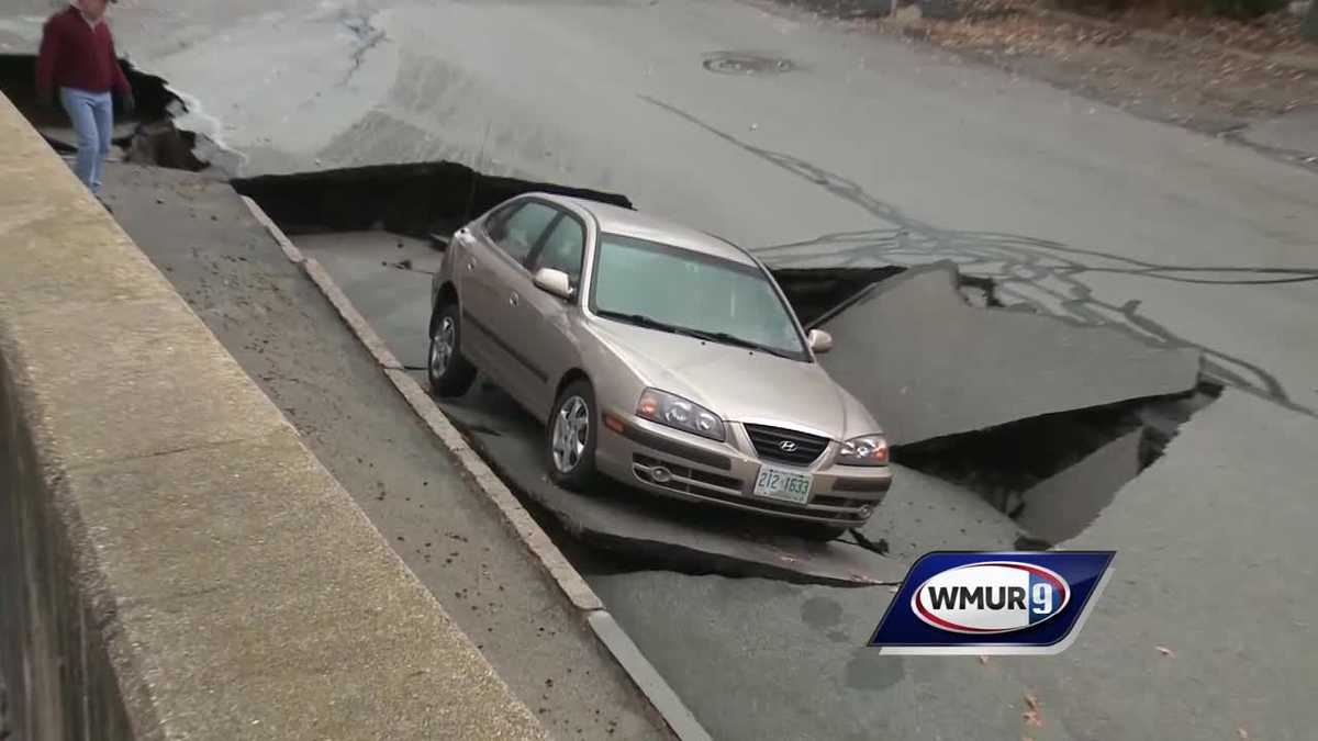 129-year-old water main breaks in Manchester; car falls into sinkhole ...