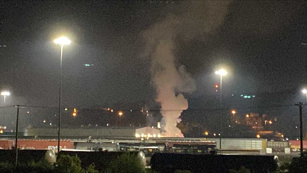 Fire crews responding to a boxcar on fire in Camp Washington