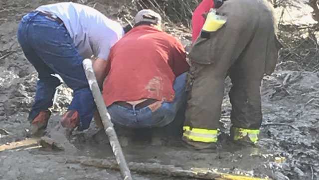 Teen saved from waist-deep mud