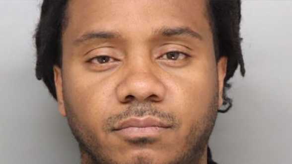 Surveillance video shows bank robbery suspect firing at police in bar