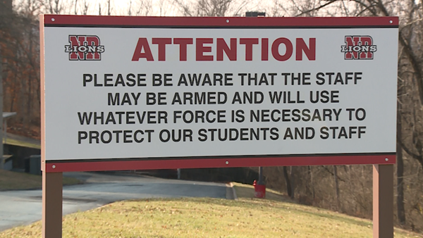 Signs saying teachers may be carrying firearms now posted outside New ...