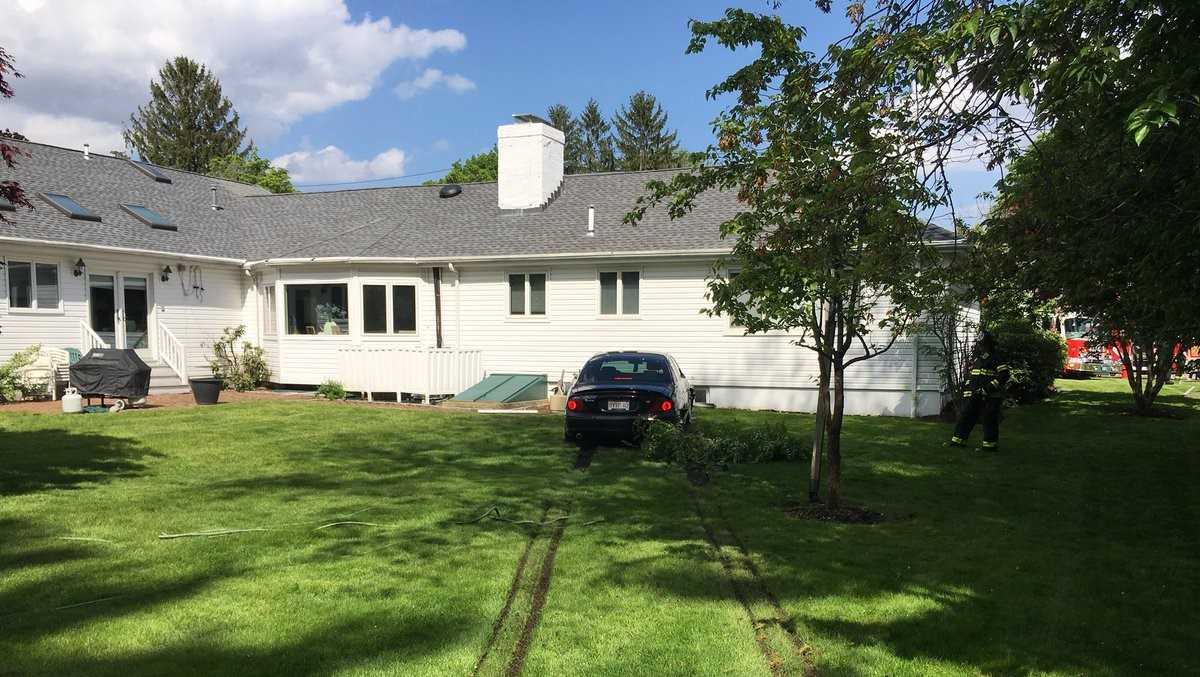 Luxury car crashes through several yards, hits house