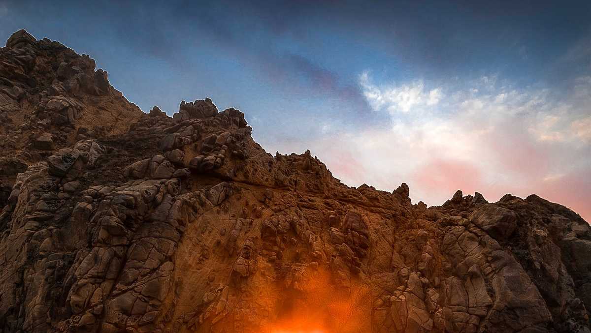 Big Sur's fiery keyhole arch alit for a limited time