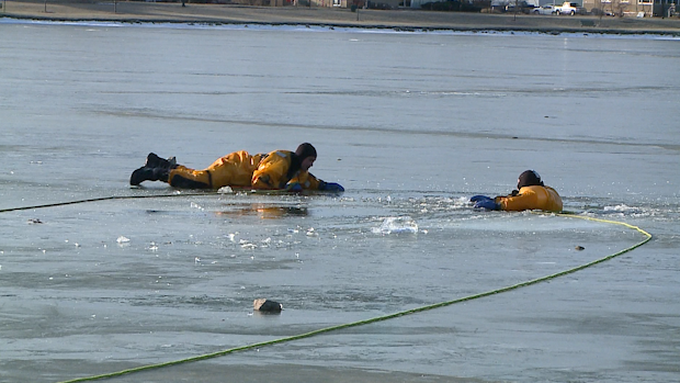 Firefighters jump into frozen lake for ice rescue training