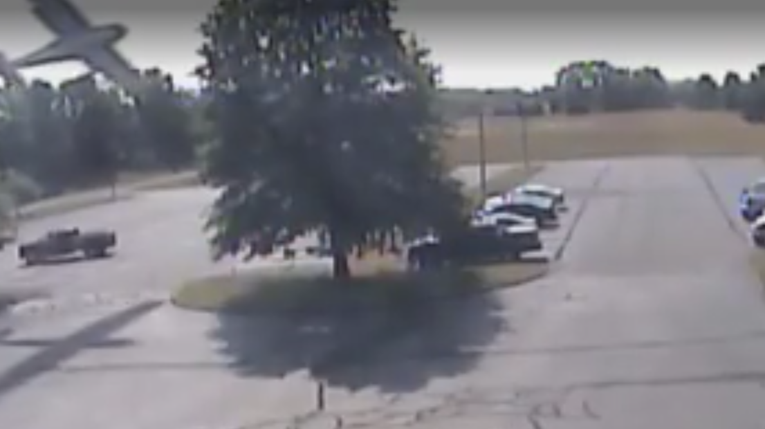 Surveillance video shows plane hitting tree, narrowly missing driver