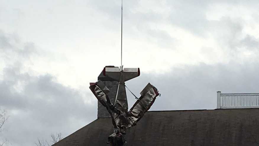 Crashed plane hoisted from roof of condo building