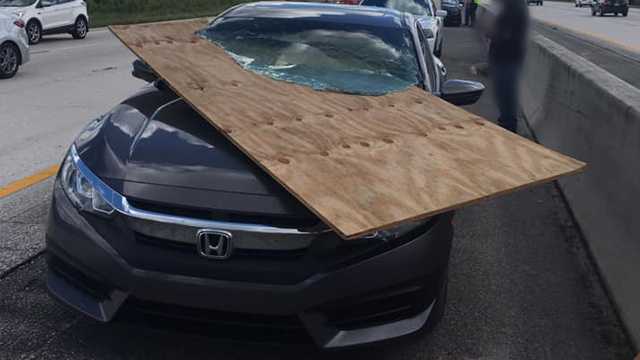 Piece of plywood slices car's windshield, narrowly misses driver