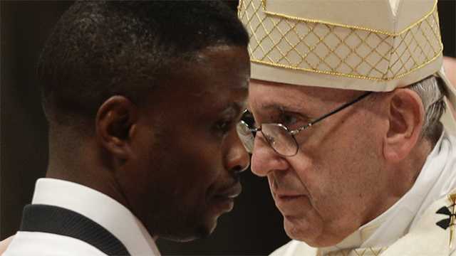 Pope Francis baptizes migrant hailed as a hero
