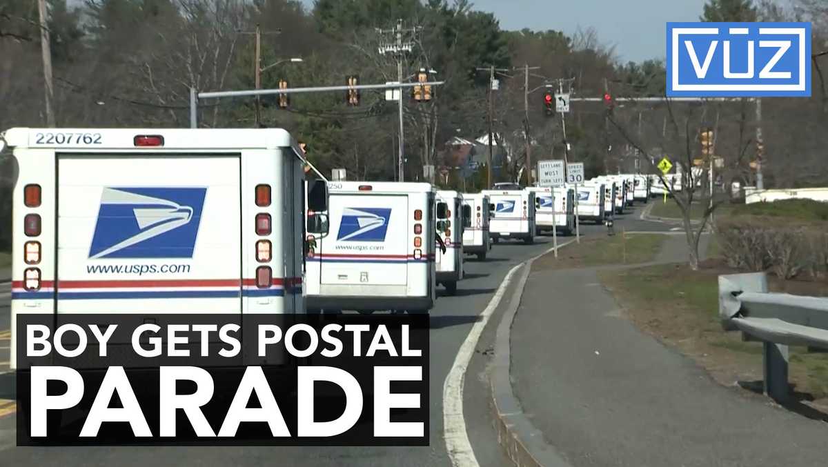 Postal workers make a special delivery to a young boy