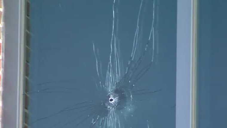 Bullet shot through window of Needham office building
