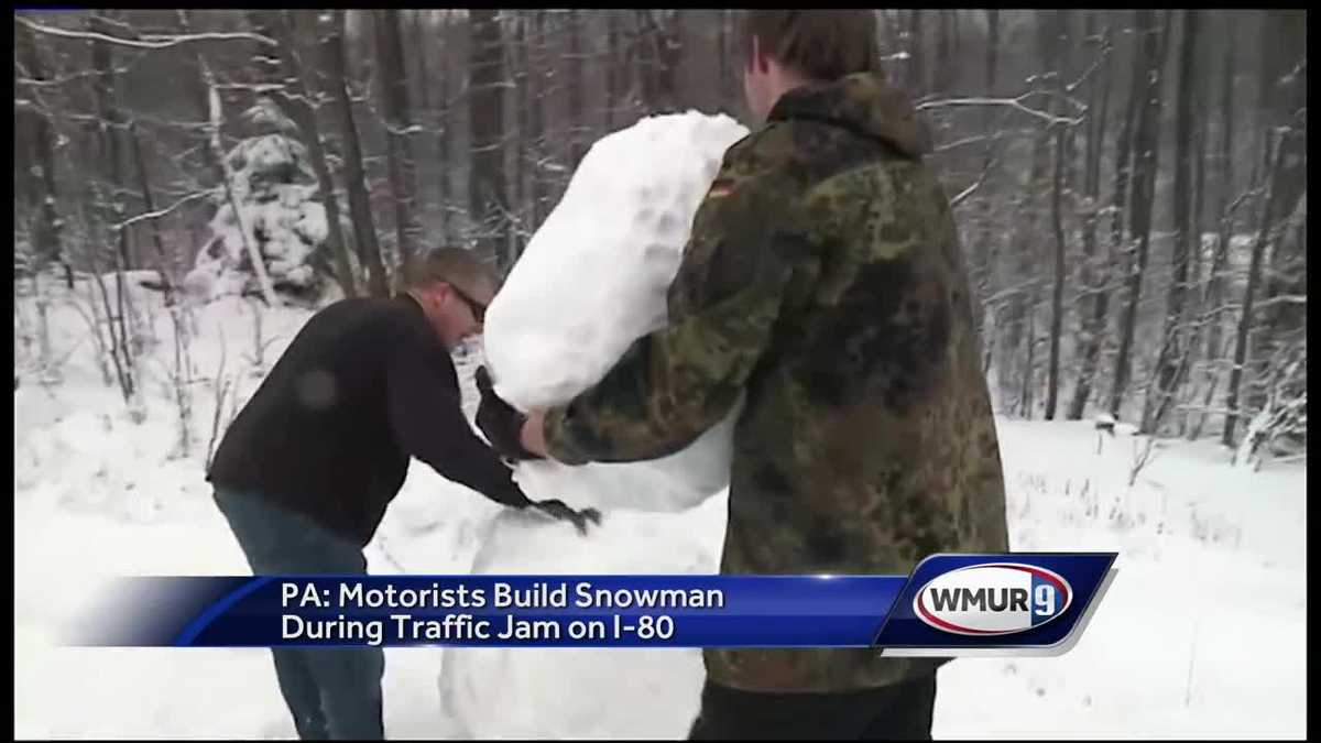 Drivers stuck in traffic jam make snowmen while waiting for highway to ...