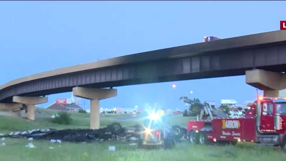 Two people taken to hospital after semitruck falls off bridge, catches ...
