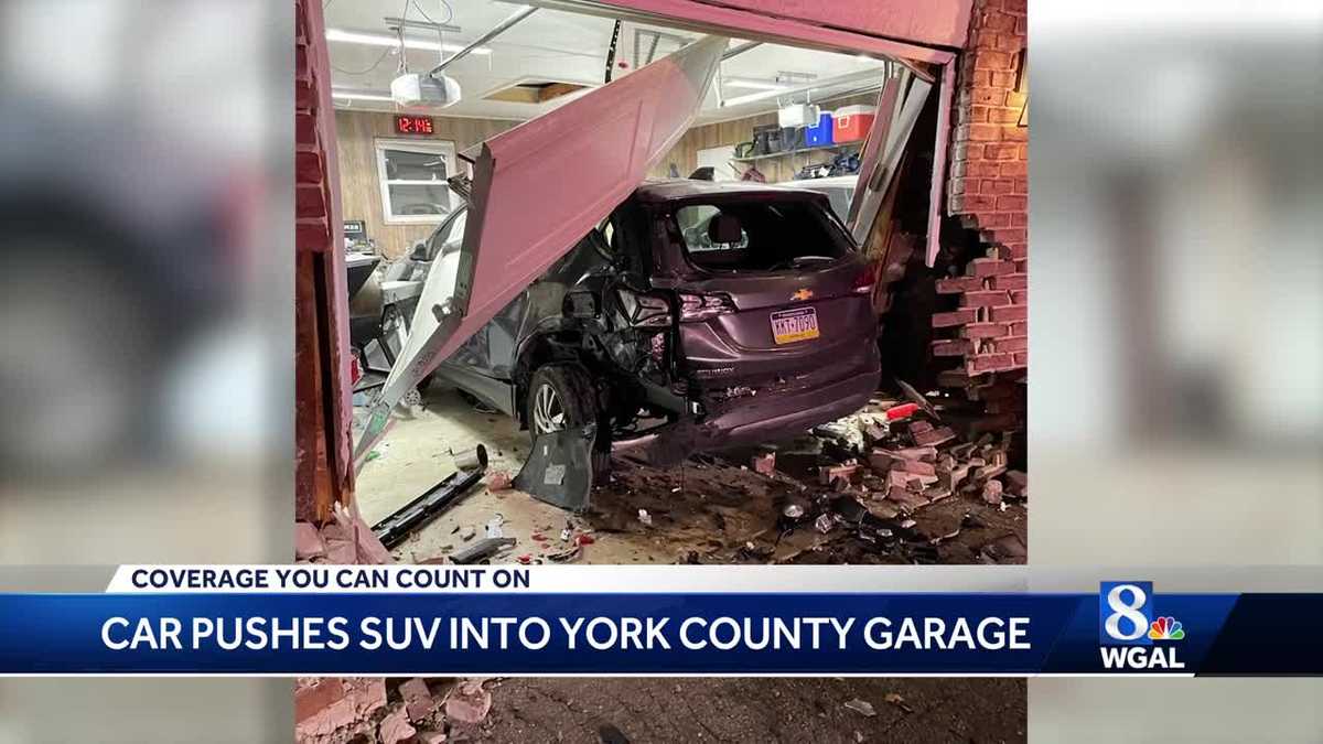 SUV smashes into garage after being hit by pickup truck
