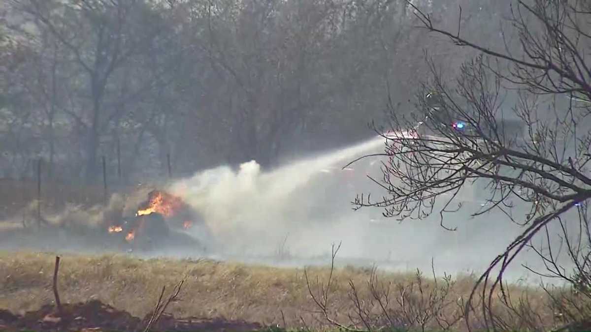 Crews rescue a home while battling grass fire in Logan County