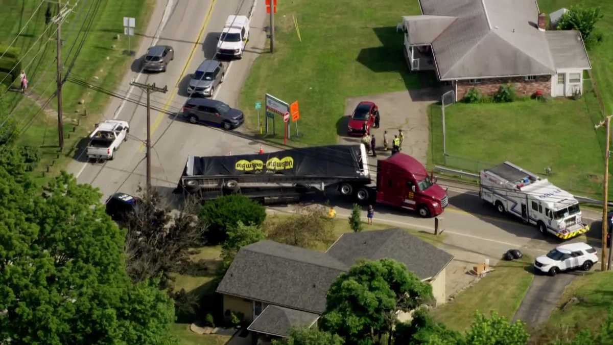 Portion of road blocked off after tractor-trailer partially overturns ...