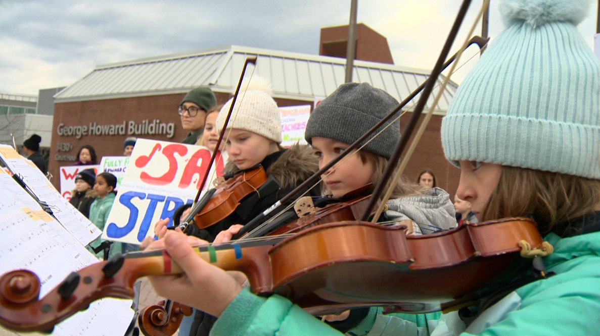 Families protest cuts to teachers, school programs