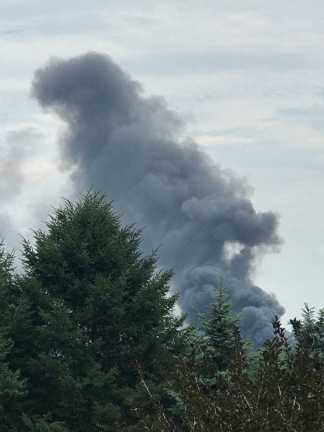 Explosions heard as fire rips through salvage yard; 1 Injured