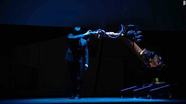 Engineer dances onstage with robot he programmed