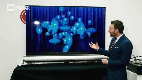 Watch this 65" TV roll up like a yoga mat