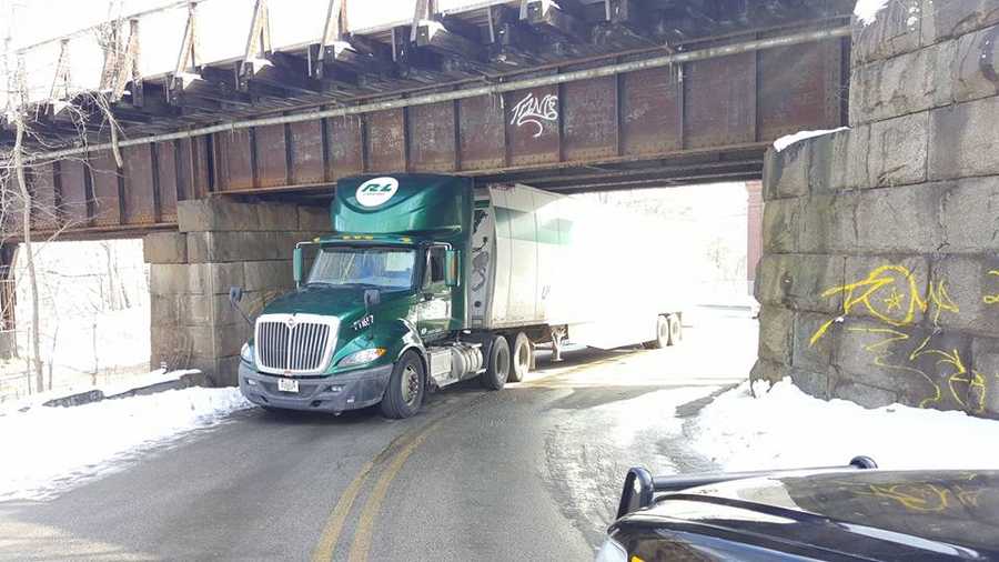 Tractor-trailer gets stuck under railroad bridge in Rollinsford