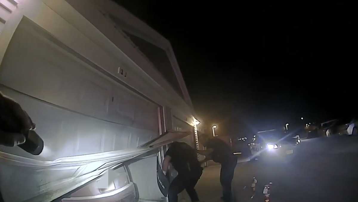 Dramatic video shows police desperately trying to save man from burning garage