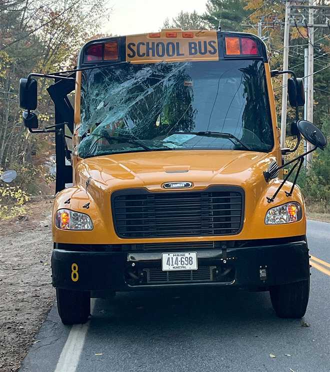 Maine school bus hit by falling utility pole struck by dump truck