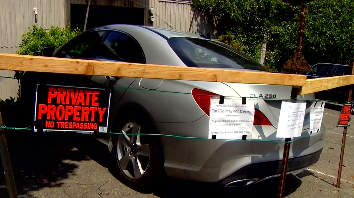 Man builds fence around car parked without permission at his duplex