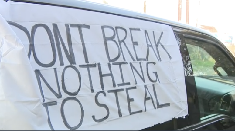 Man hangs sign on truck to deter break-ins
