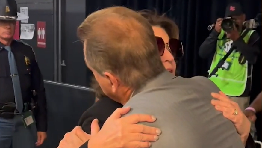 Coach Saban and Miss Terry embrace at the SEC Championship