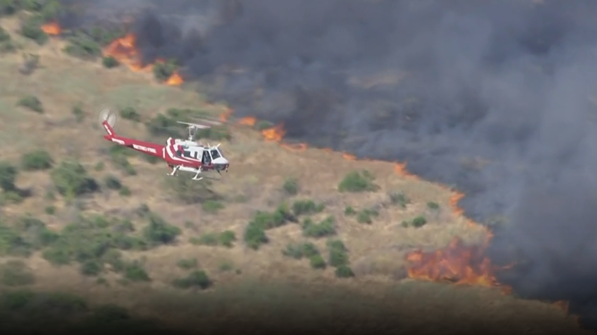 One in custody after a fire spreads across hundreds of acres in Mather
