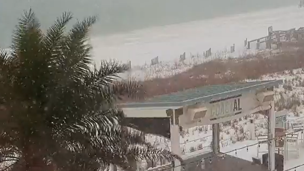Video shows snow falling onto the sand at Orange Beach