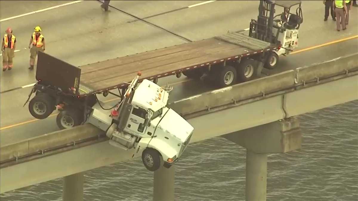 Accident leaves truck dangling over Gulf Coast bridge
