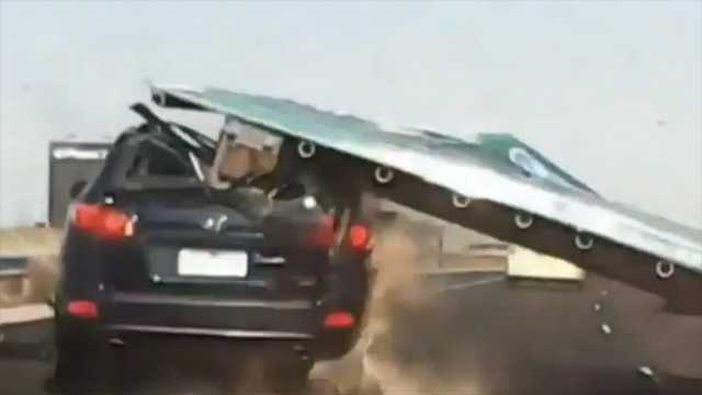 Terrifying video shows moment SUV is crushed by road sign