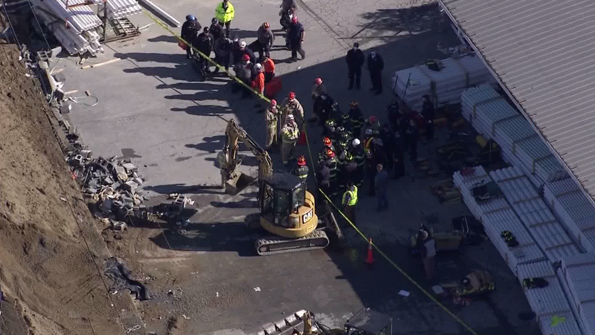 One dead, four injured after retaining wall collapse in parking lot of ...