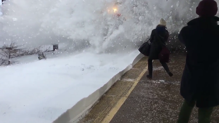 Watch out! Passengers get covered in snow after train plows through