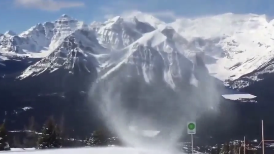 Snowboarder rides in rare 'snownado'