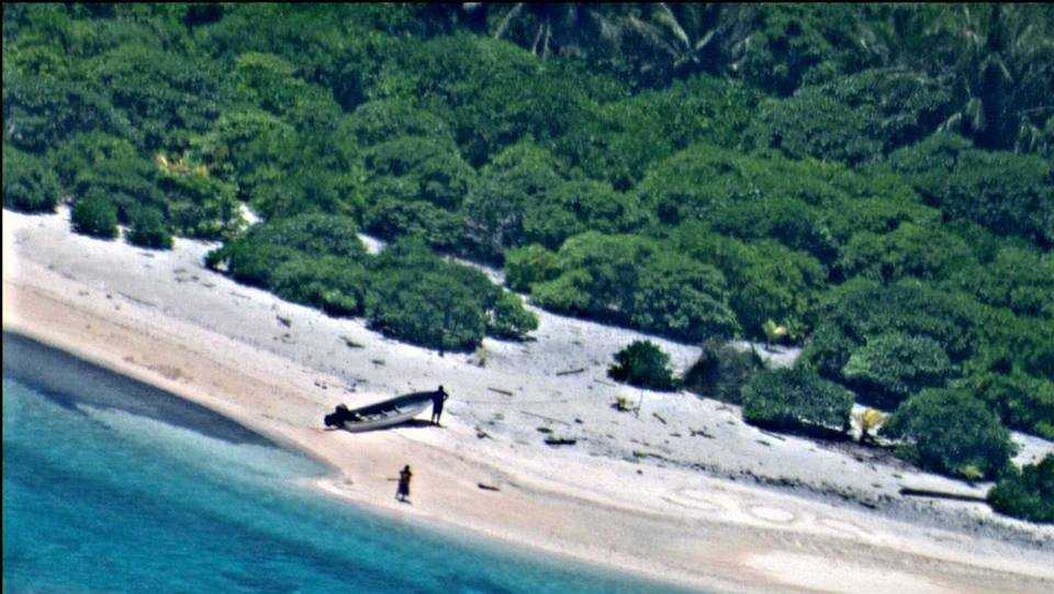Photos: Stranded couple rescued after drawing SOS message in sand
