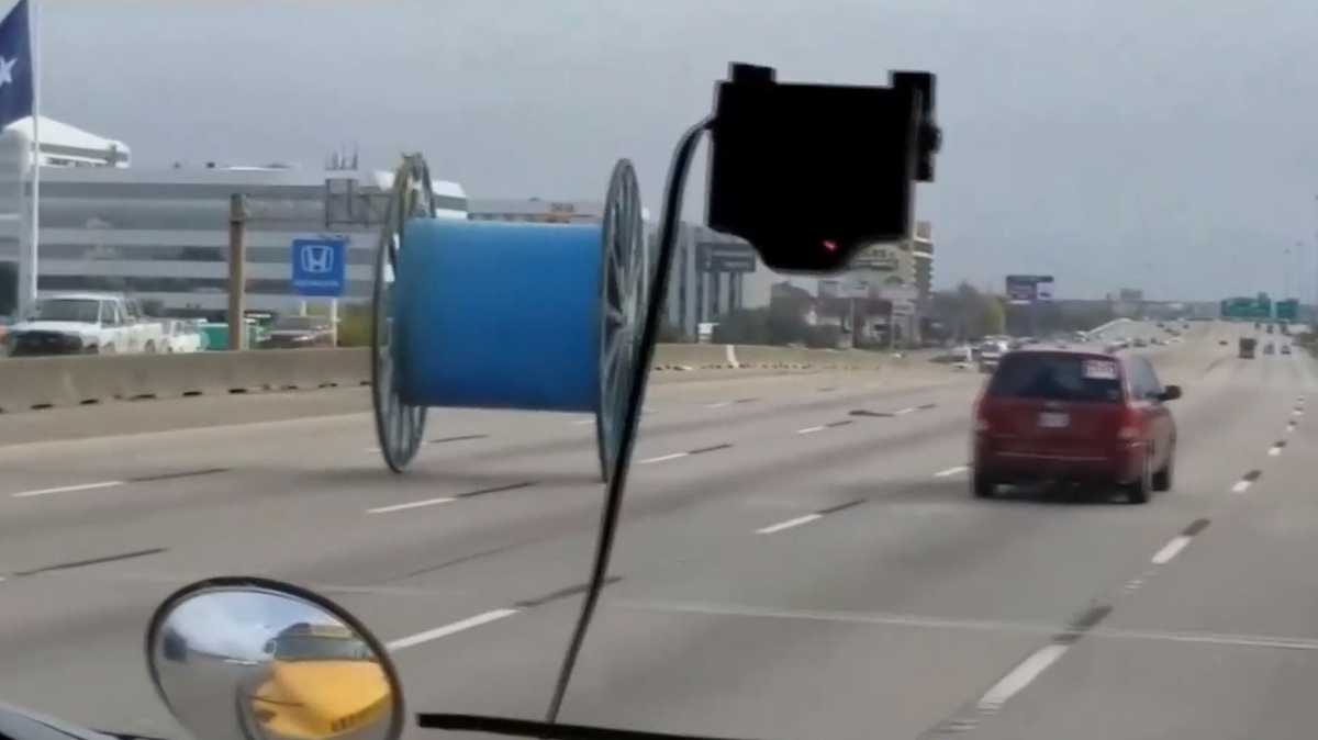 Watch: Drivers struggle to dodge giant industrial spool rolling down ...