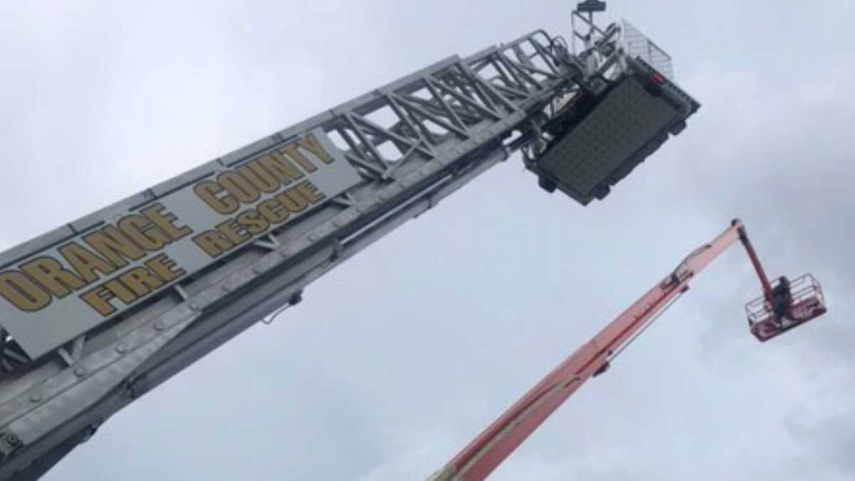 Firefighters rescue man stuck 70 feet up in boom truck