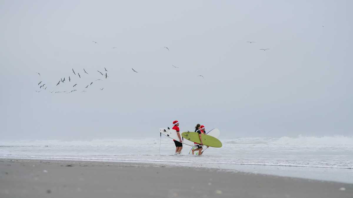 Surfing Santas brave cold on Christmas Eve for annual Cocoa Beach event