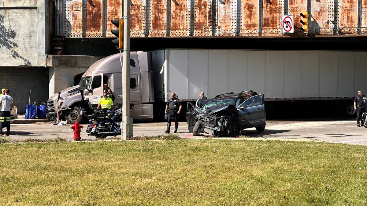 Semitrailer and SUV crash, SUV totaled and towed