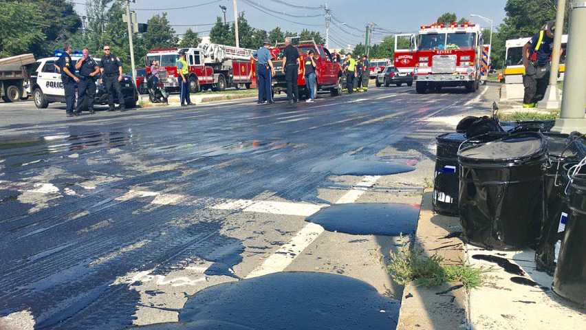 Cans of tar spill on roadway, cause scooter crash
