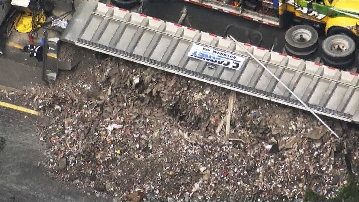 Truck hauling garbage flips over on Middleborough highway ramp