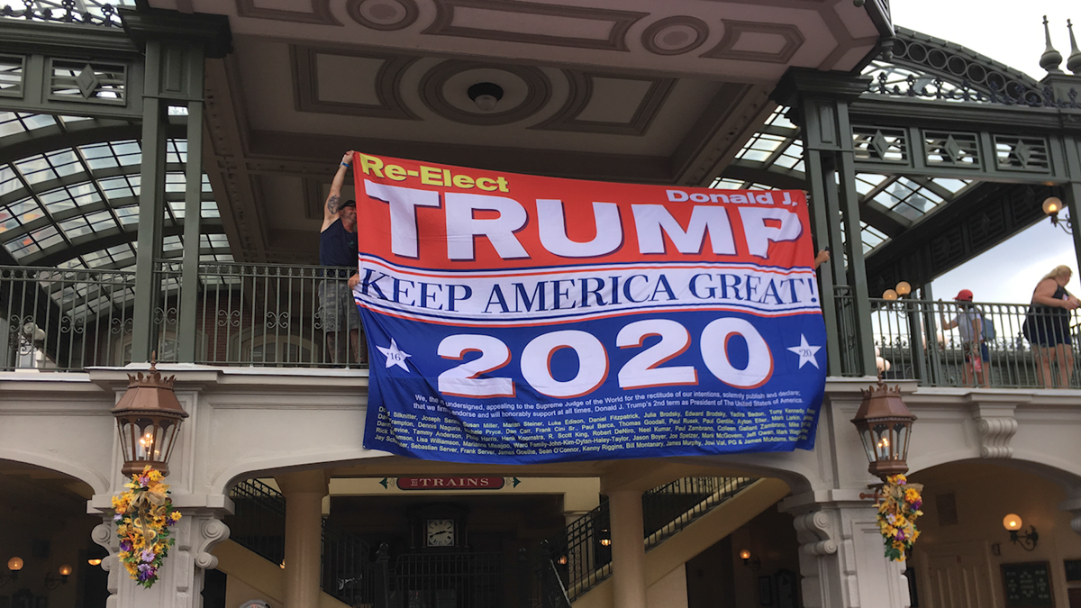 Man hangs Trump re-election banner at Magic Kingdom