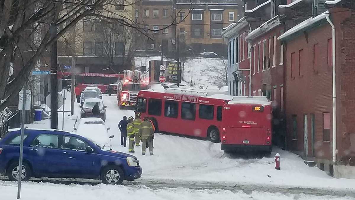 Port Authority articulated bus jackknifes into rowhouse on snowy street ...