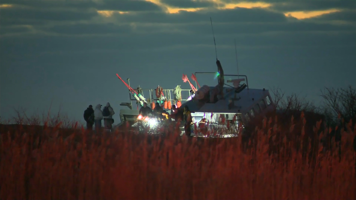 Fishing crew stranded after boat gets stuck on rocks