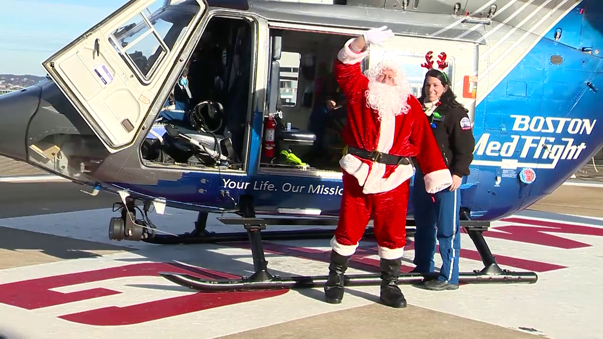 Up on the rooftop propellers pause, out of a helicopter jumps Santa Claus